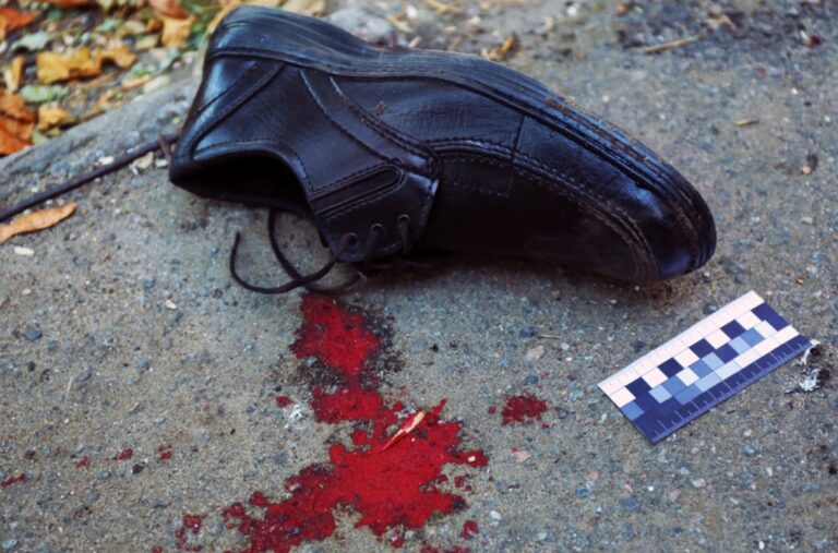 PHOTO Shoe Of Victim And Blood Splattered On The Ground Outside Of Tops ...