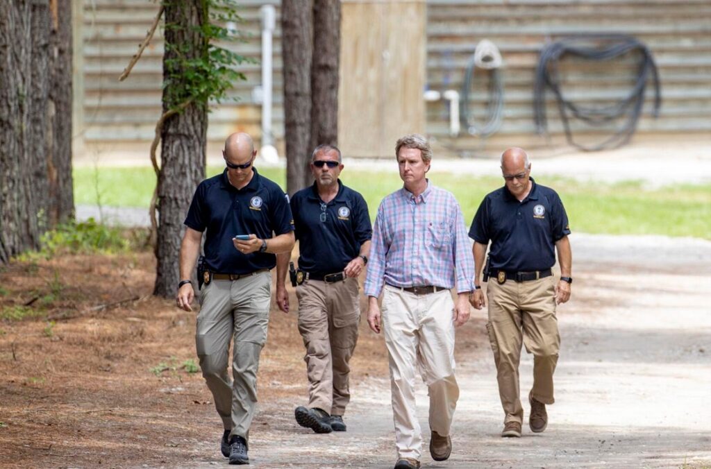 PHOTO John Marvin Walking With SLED Agents