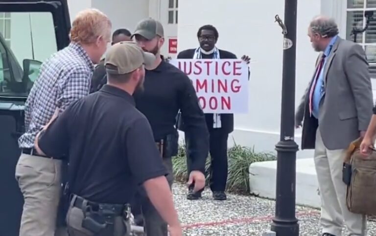 PHOTO Preacher Standing Outside Courthouse Door With Sign That Says ...