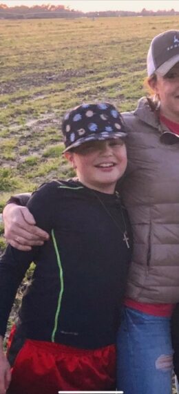 PHOTO Colt Grey Wearing A Cross Around His Neck While His Mother's Arm ...