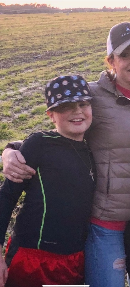 PHOTO Colt Grey Wearing A Cross Around His Neck While His Mother's Arm ...