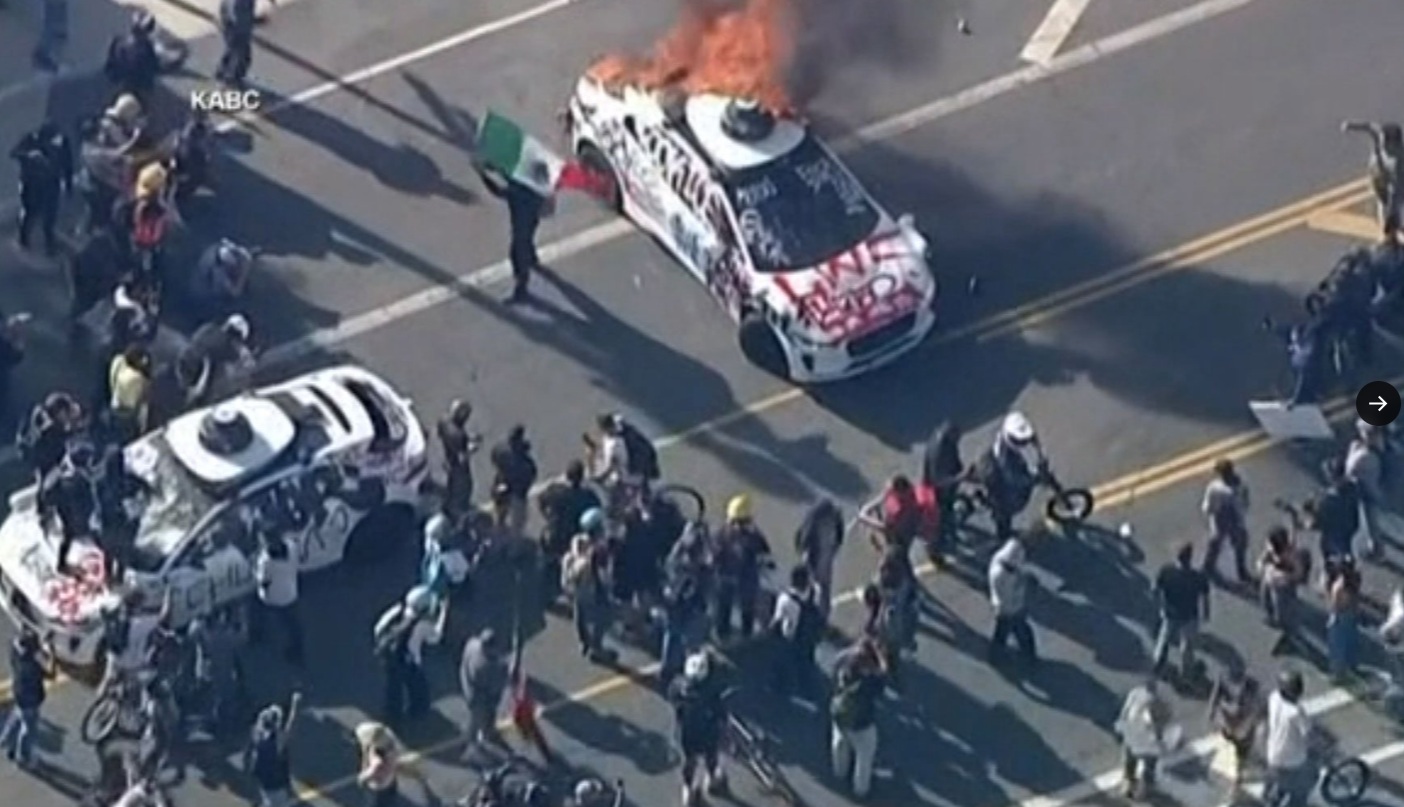 PHOTO LA Protesters Casually Watching Waymo On Fire