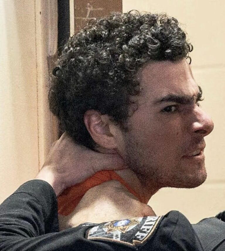 PHOTO Luigi Mangione Getting Squeezed In The Neck While In Custody